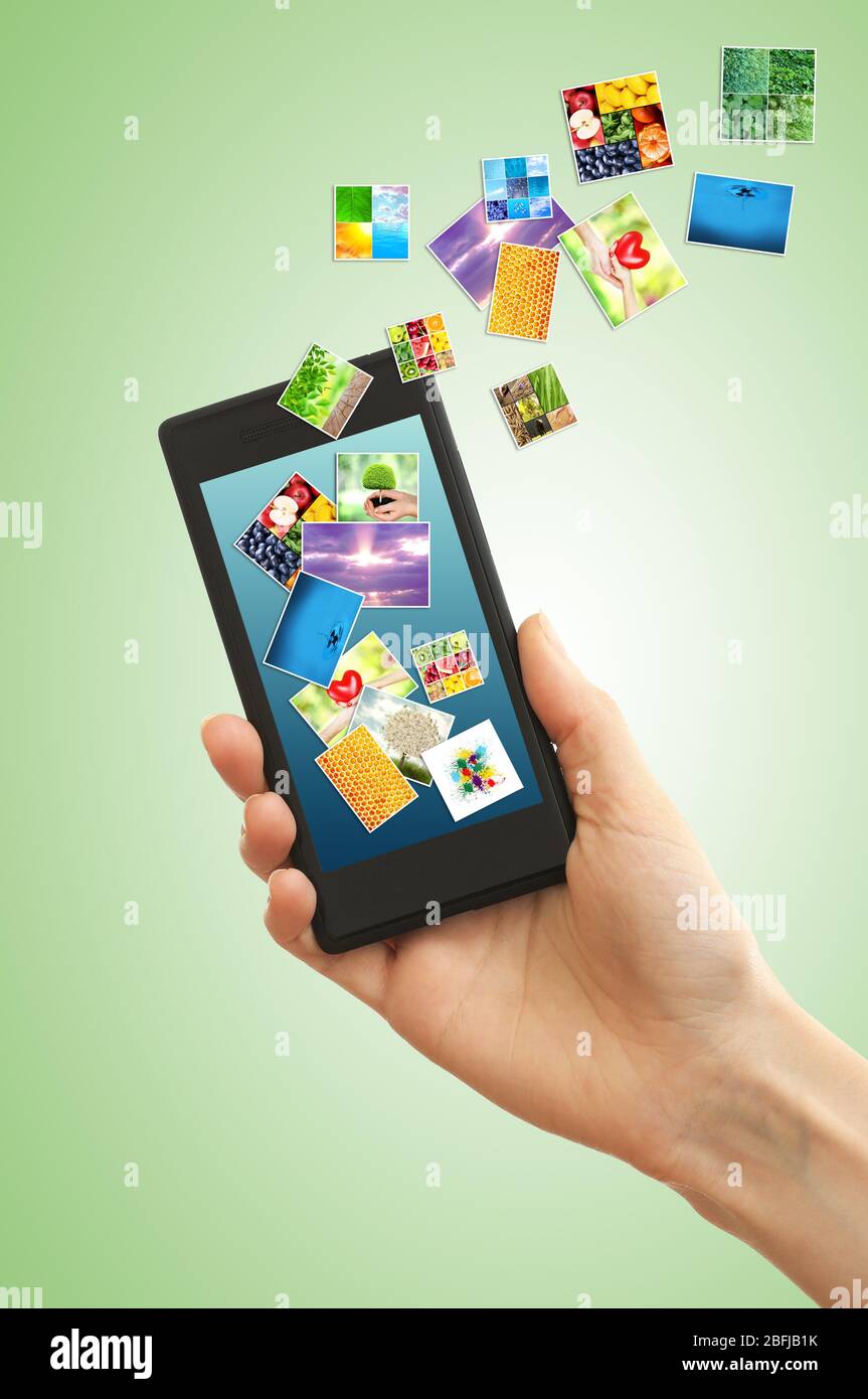 Touch screen mobile phone with streaming images on green background ...