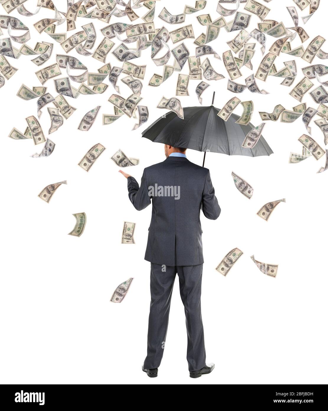 Businessman standing in the rain of money Stock Photo - Alamy