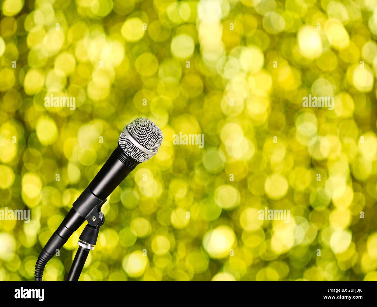 Microphone on bright yellow background Stock Photo - Alamy