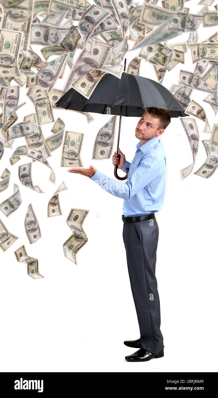 Businessman standing in the rain of money Stock Photo - Alamy