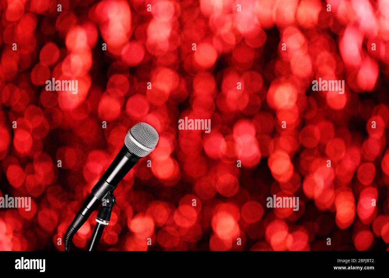Microphone on bright red background Stock Photo - Alamy