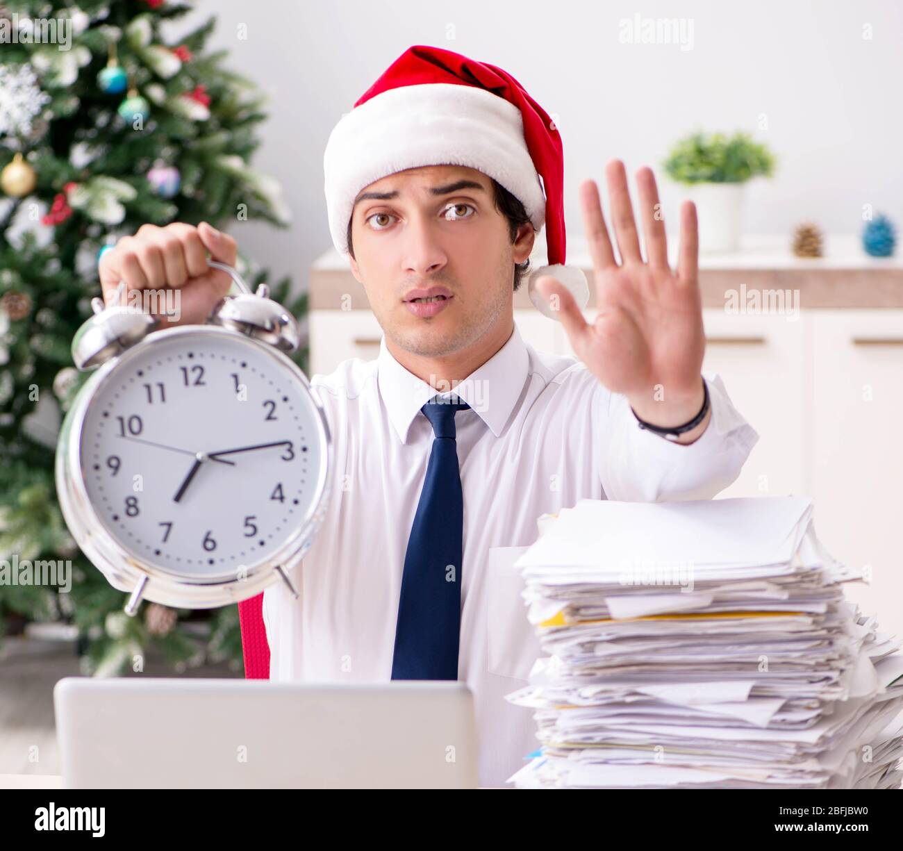 The young worker working in office on christmas shift Stock Photo - Alamy