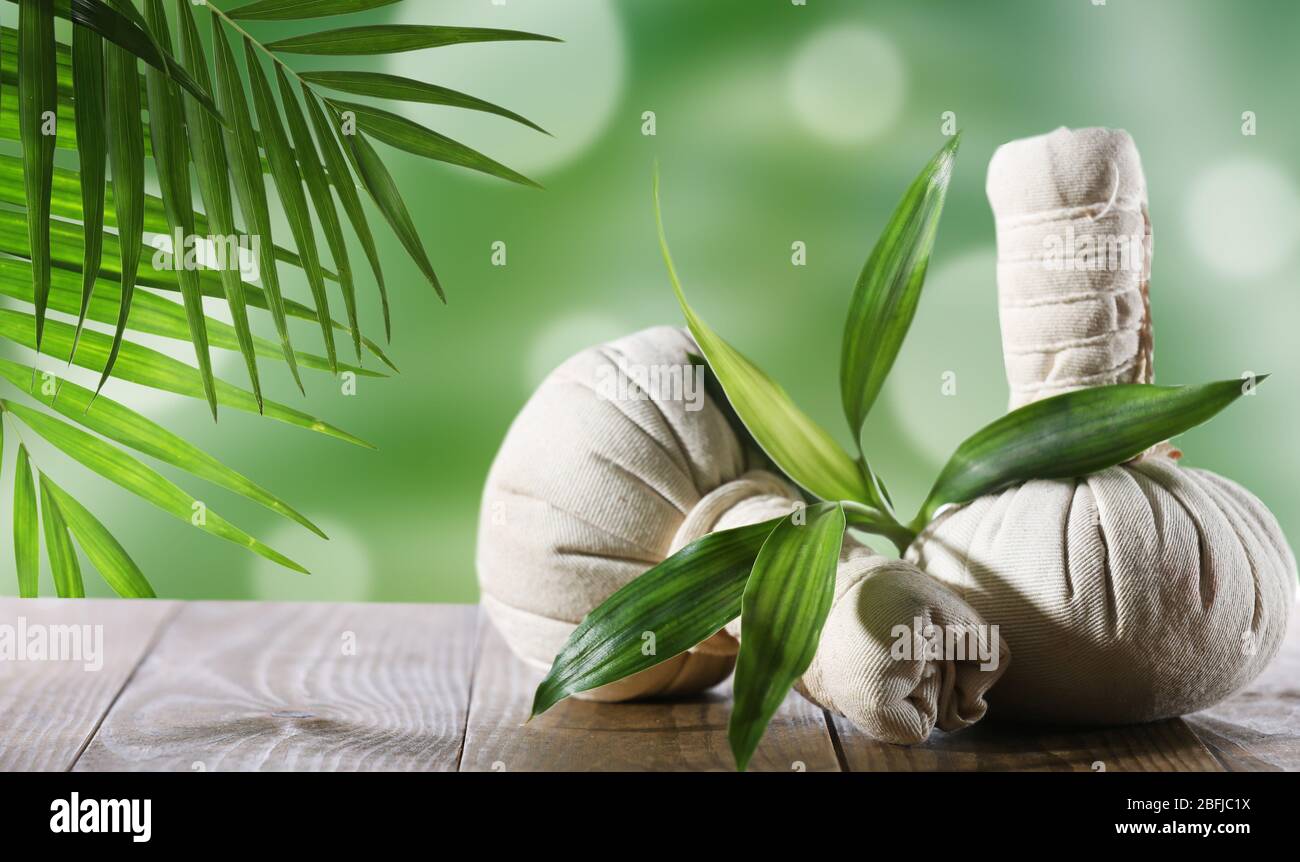 Spa compress balls with green leaves on green background Stock Photo ...