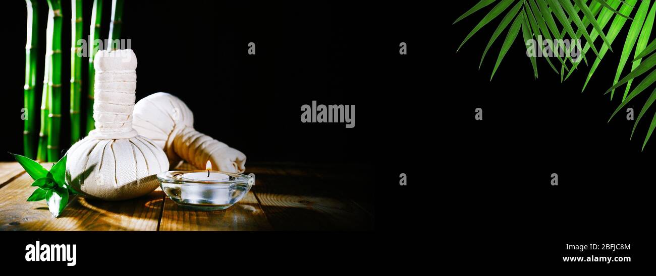 Spa compress balls with green leaves on black background Stock Photo ...