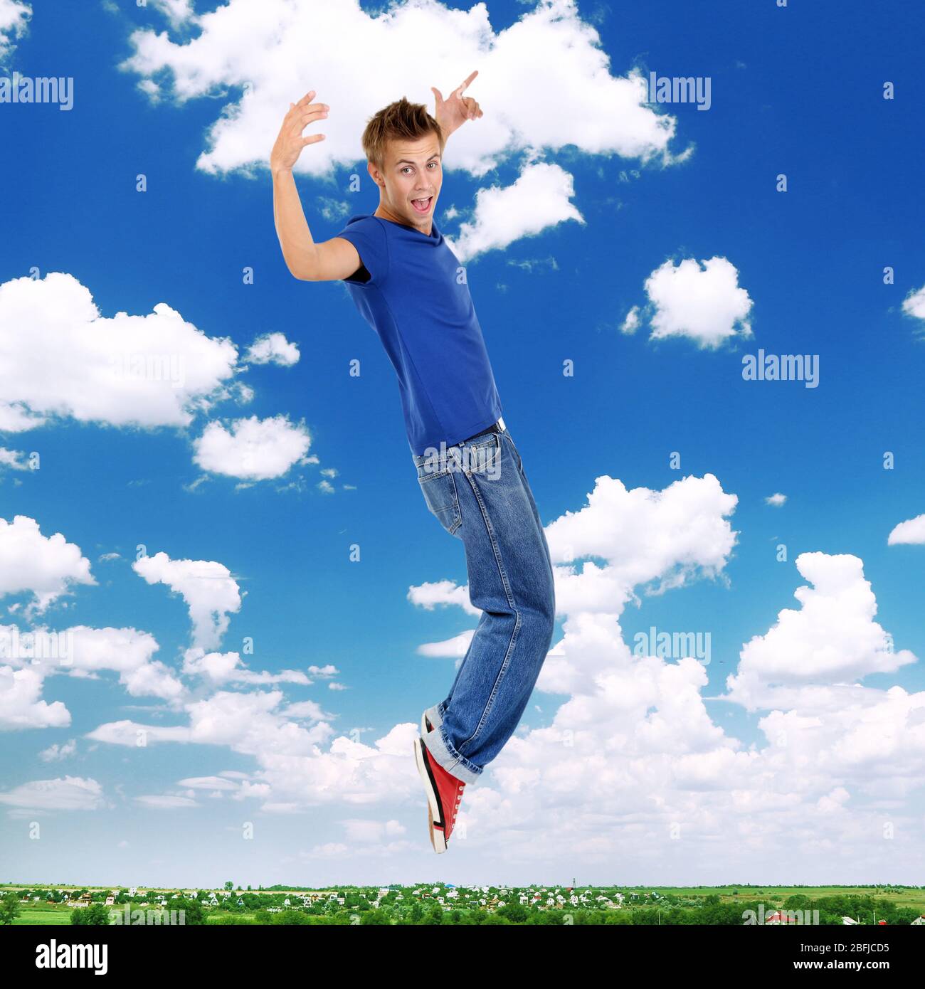 Jumping guy on sky background Stock Photo - Alamy