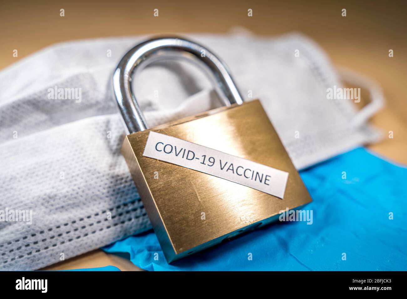 padlock over a face mask and blue medical glove Stock Photo - Alamy