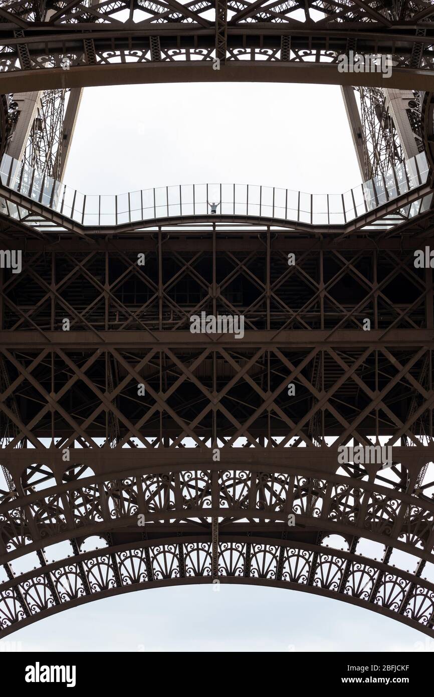 Low-angle view of a a single person leaning against the barrier on the ...