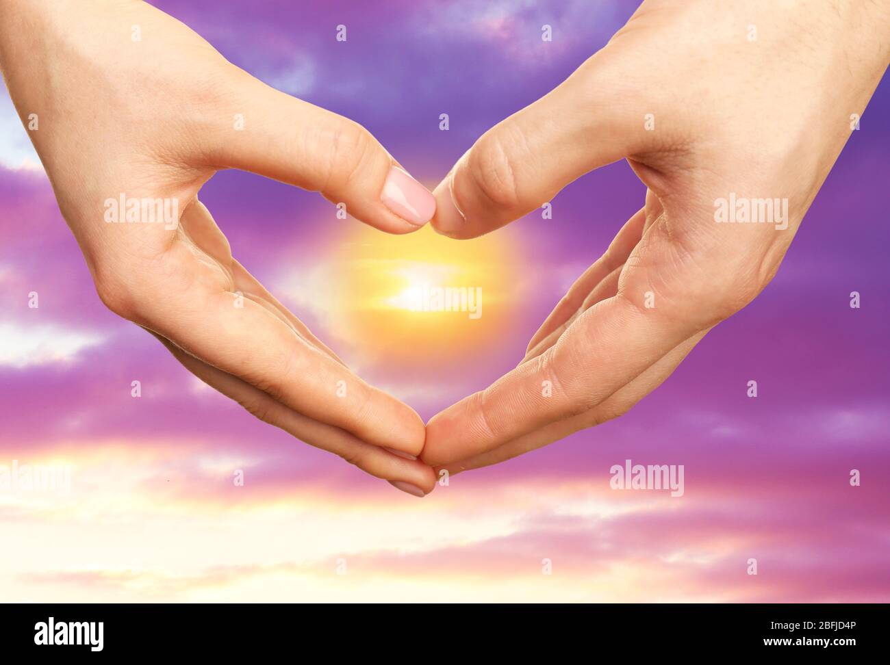 Heart shaped by hands on sky background Stock Photo - Alamy