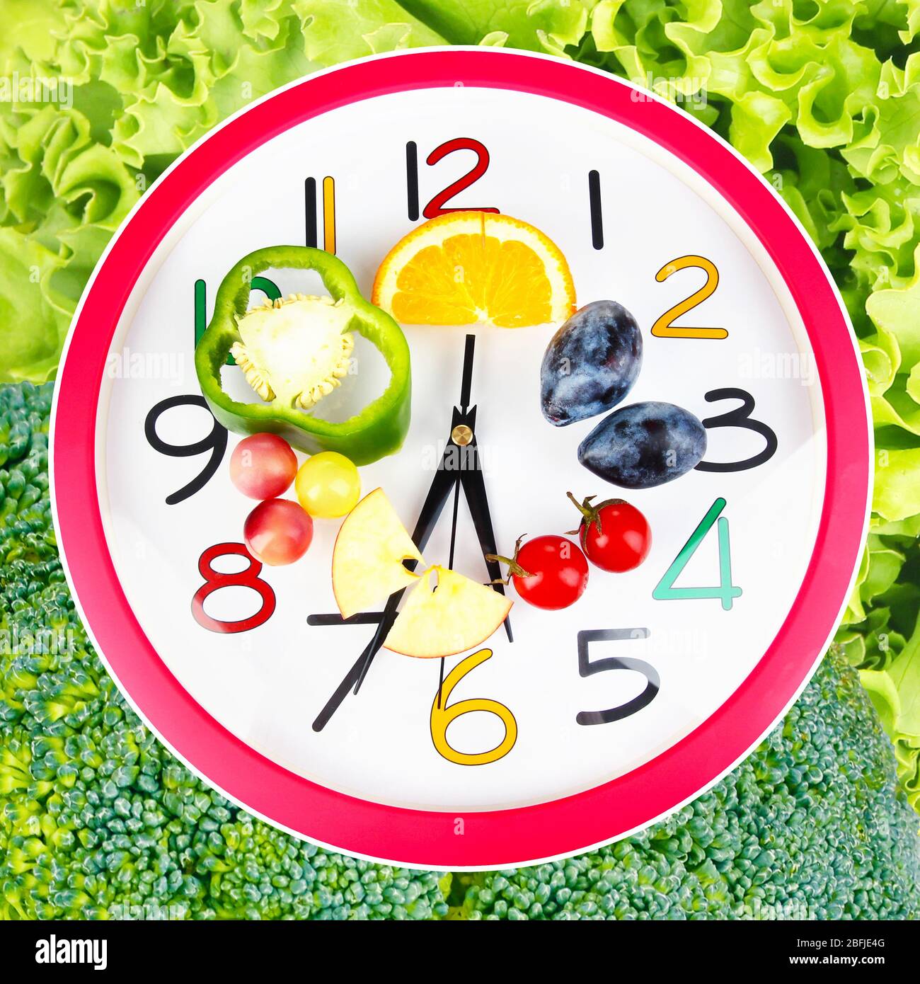Food clock with vegetables and fruits as background. Healthy food ...