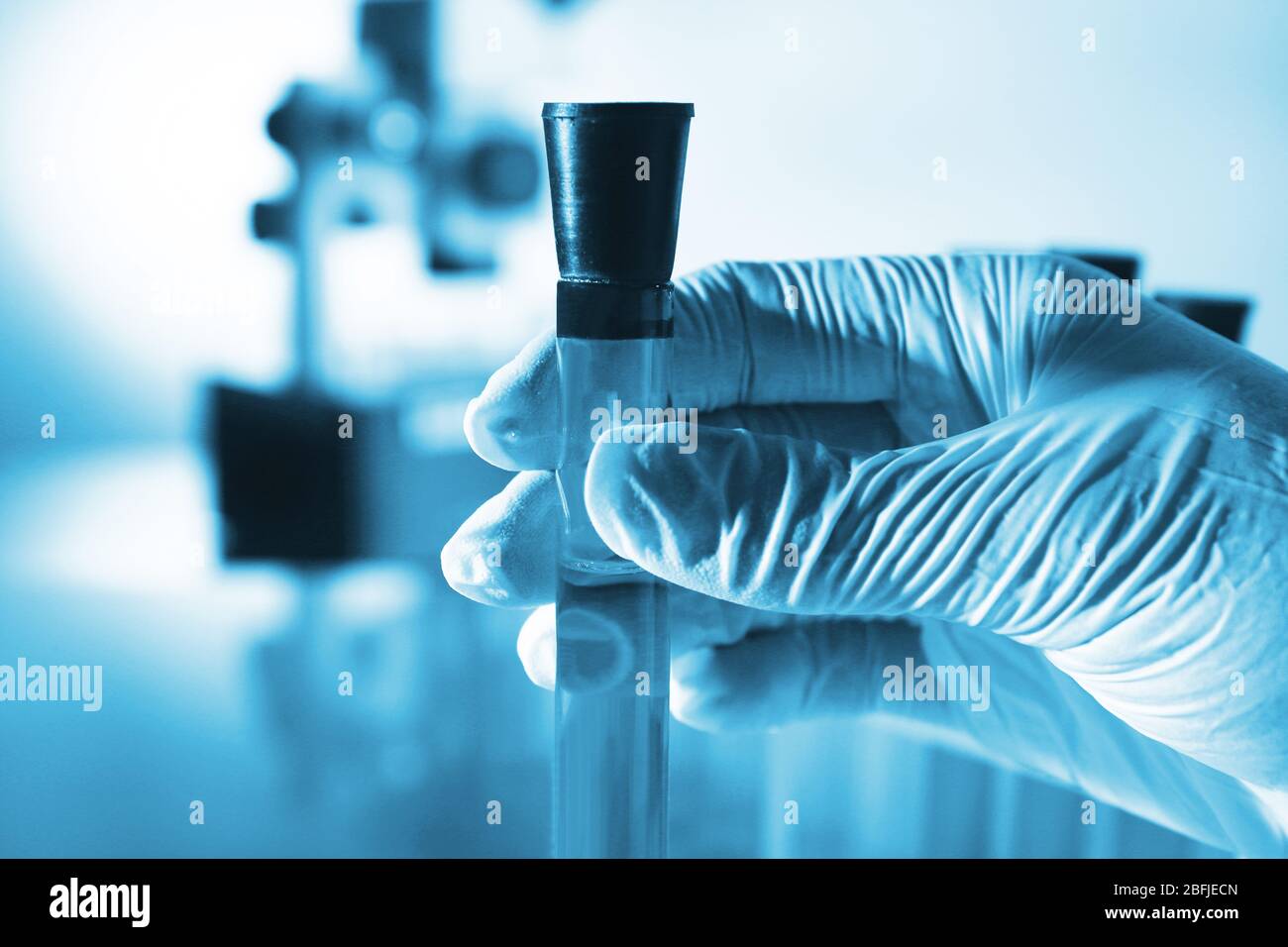 Test tube in scientist hand in laboratory Stock Photo - Alamy