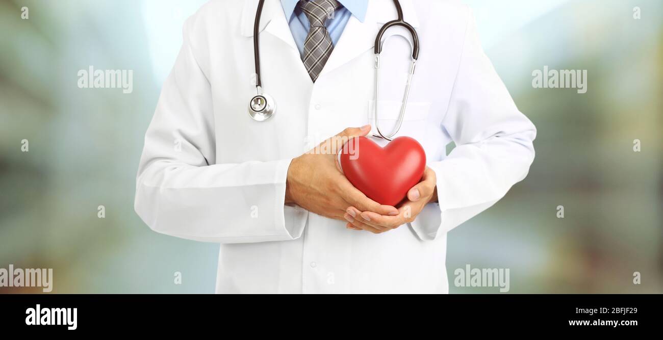 Doctor with heart in hospital Stock Photo - Alamy