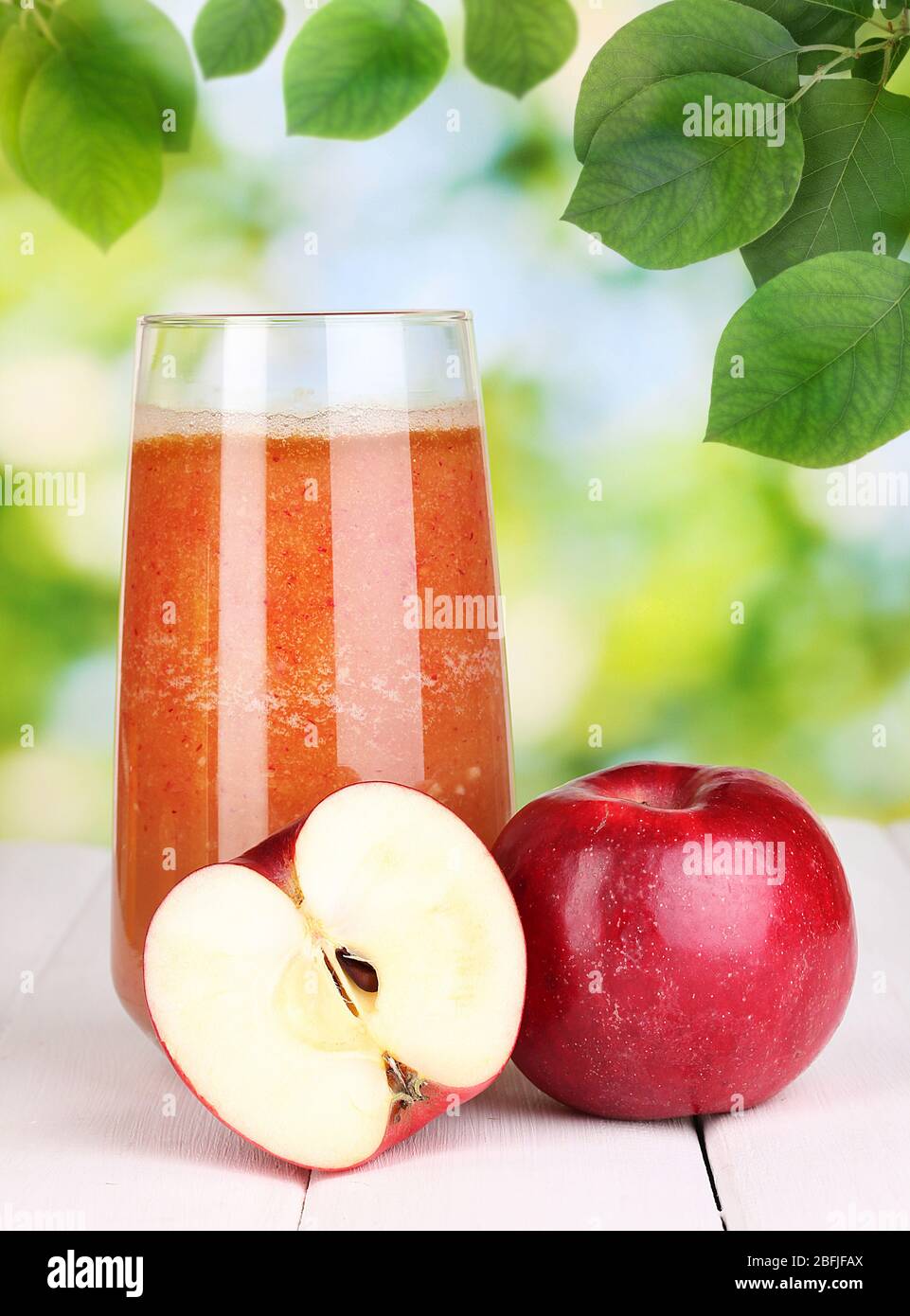 Fresh apple juice on nature background Stock Photo - Alamy