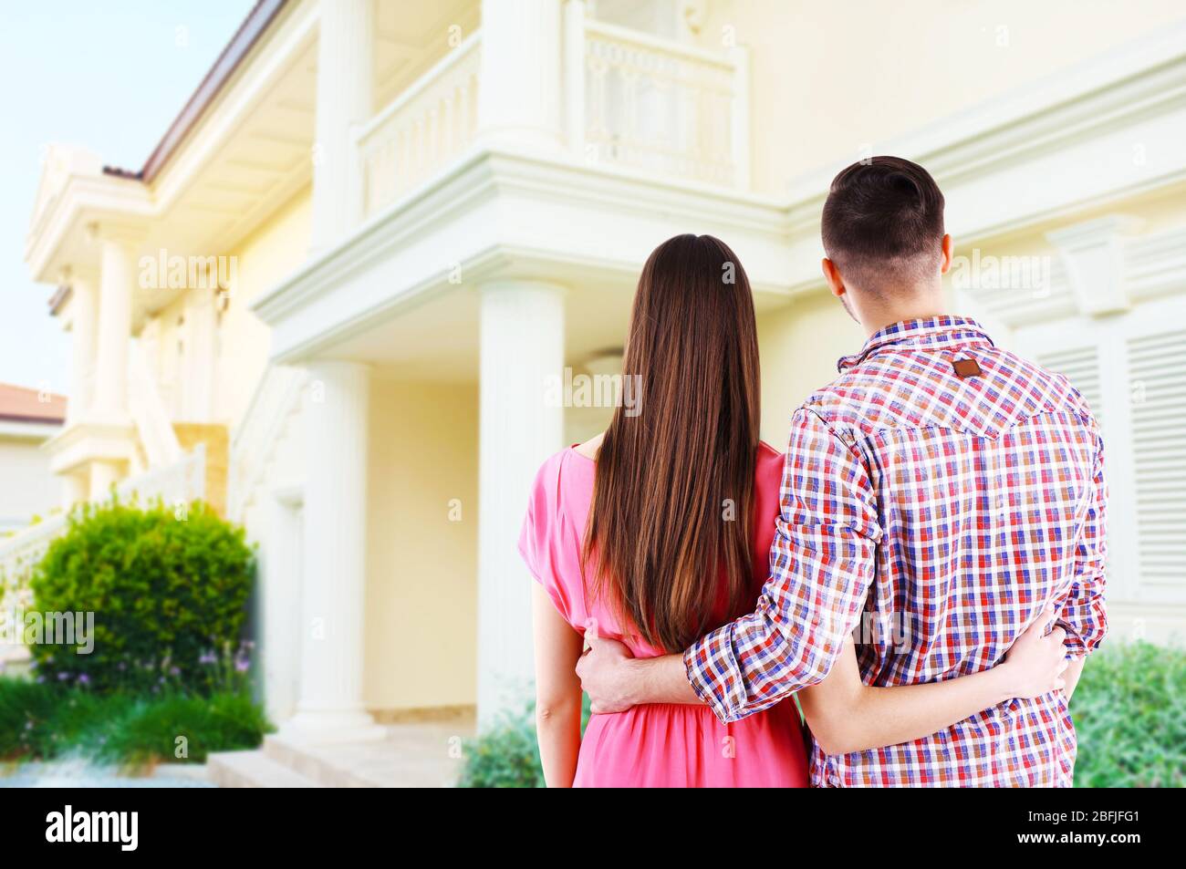 Loving couple looking at their dream house Stock Photo - Alamy