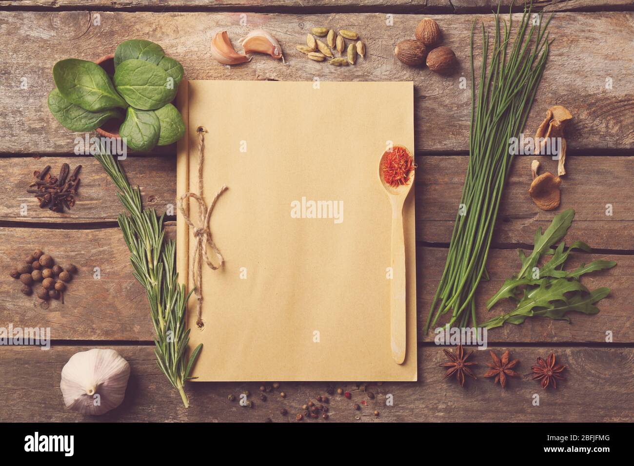 Recipe book page with different herbs on wooden background Stock Photo ...