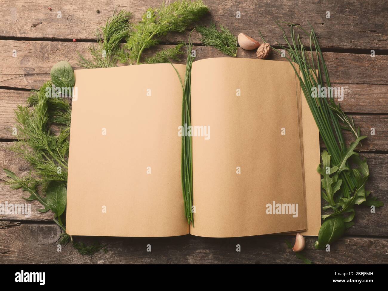 Open recipe book with fresh herbs and spices on wooden background Stock ...