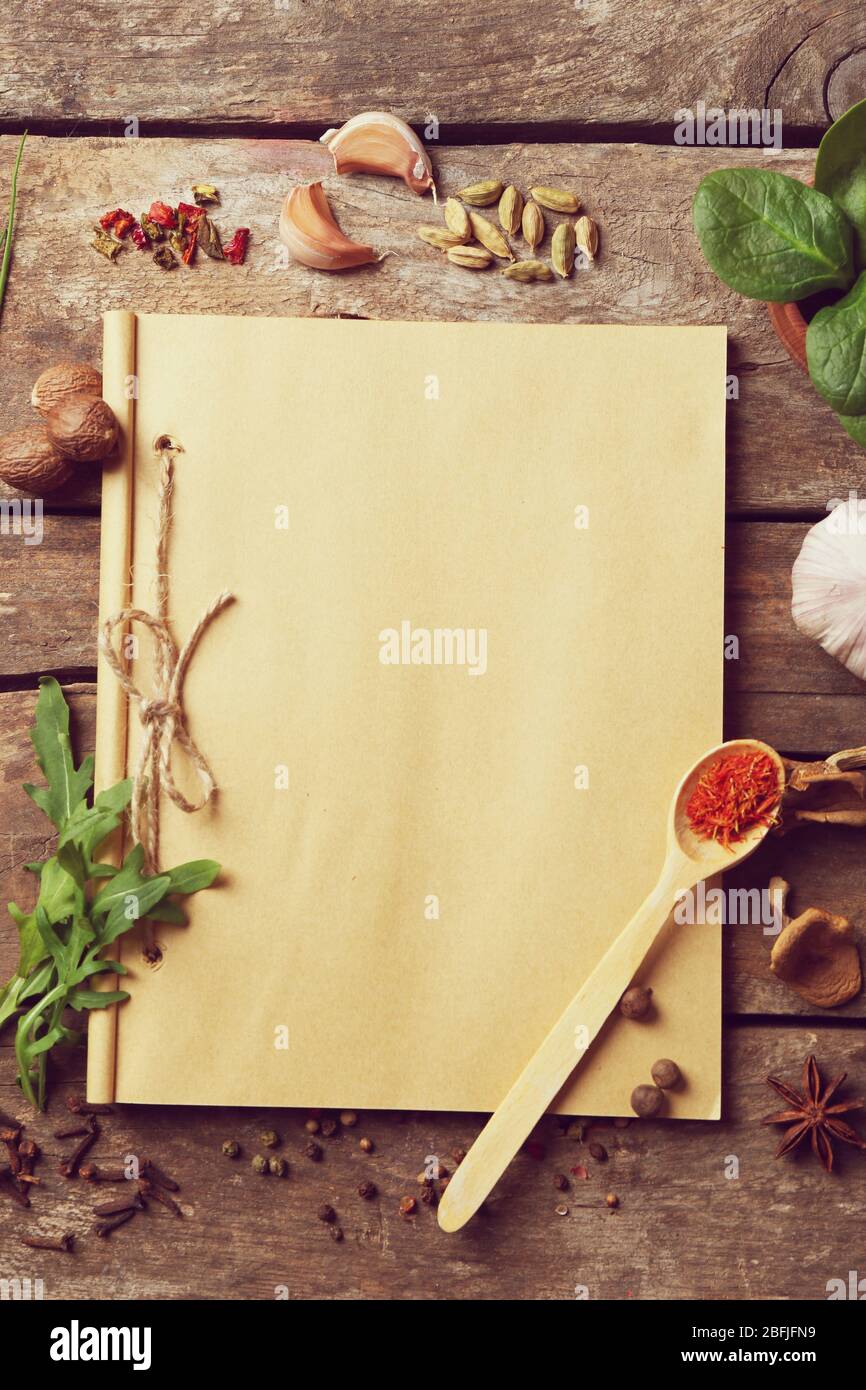 Recipe book page with different herbs on wooden background Stock Photo ...