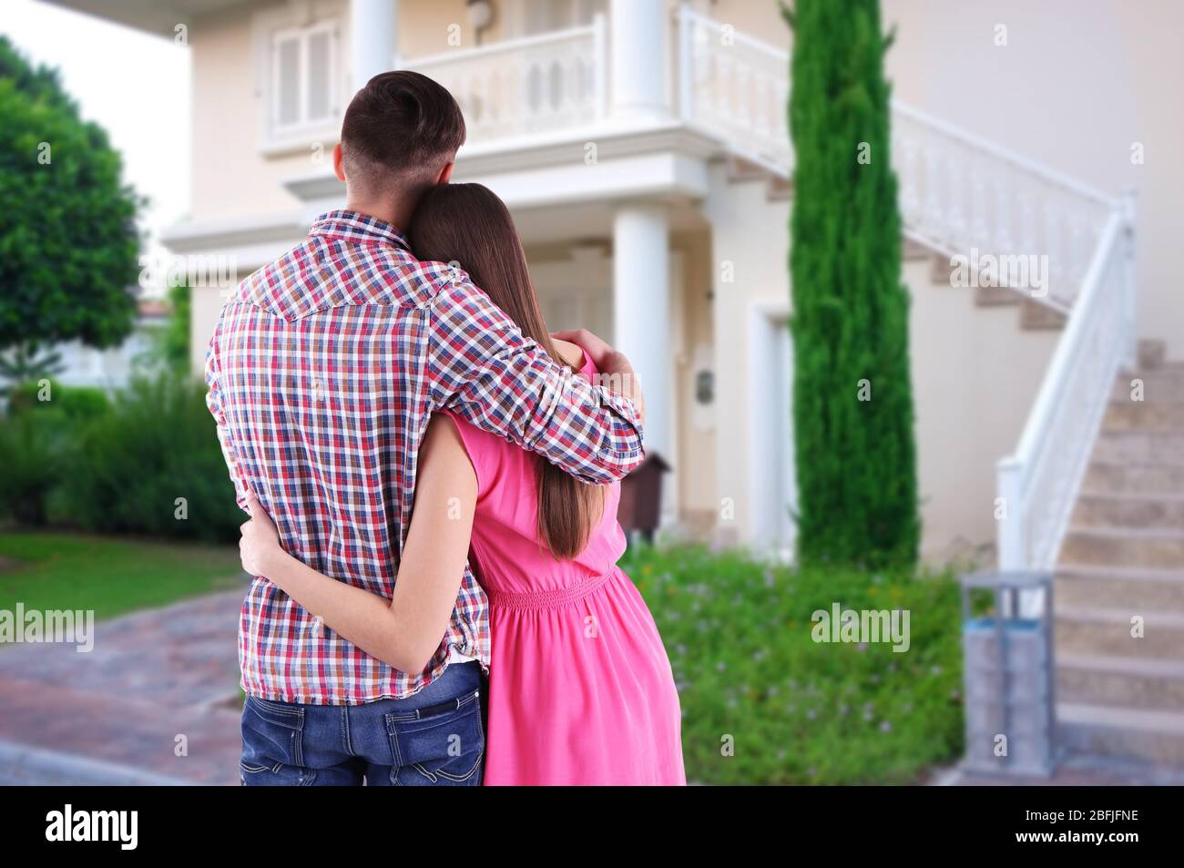 Loving couple looking at their dream house Stock Photo - Alamy