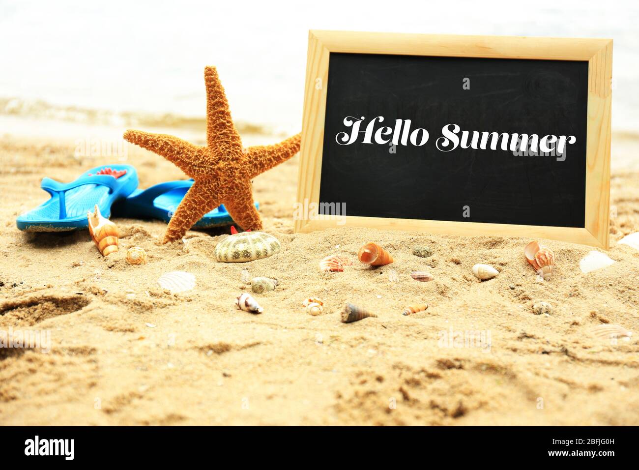Hello summer concept. Chalkboard on beach background Stock Photo - Alamy