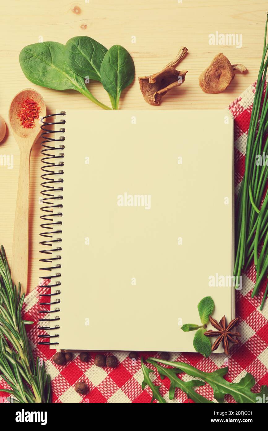 Recipe book page with different herbs on wooden background Stock Photo ...