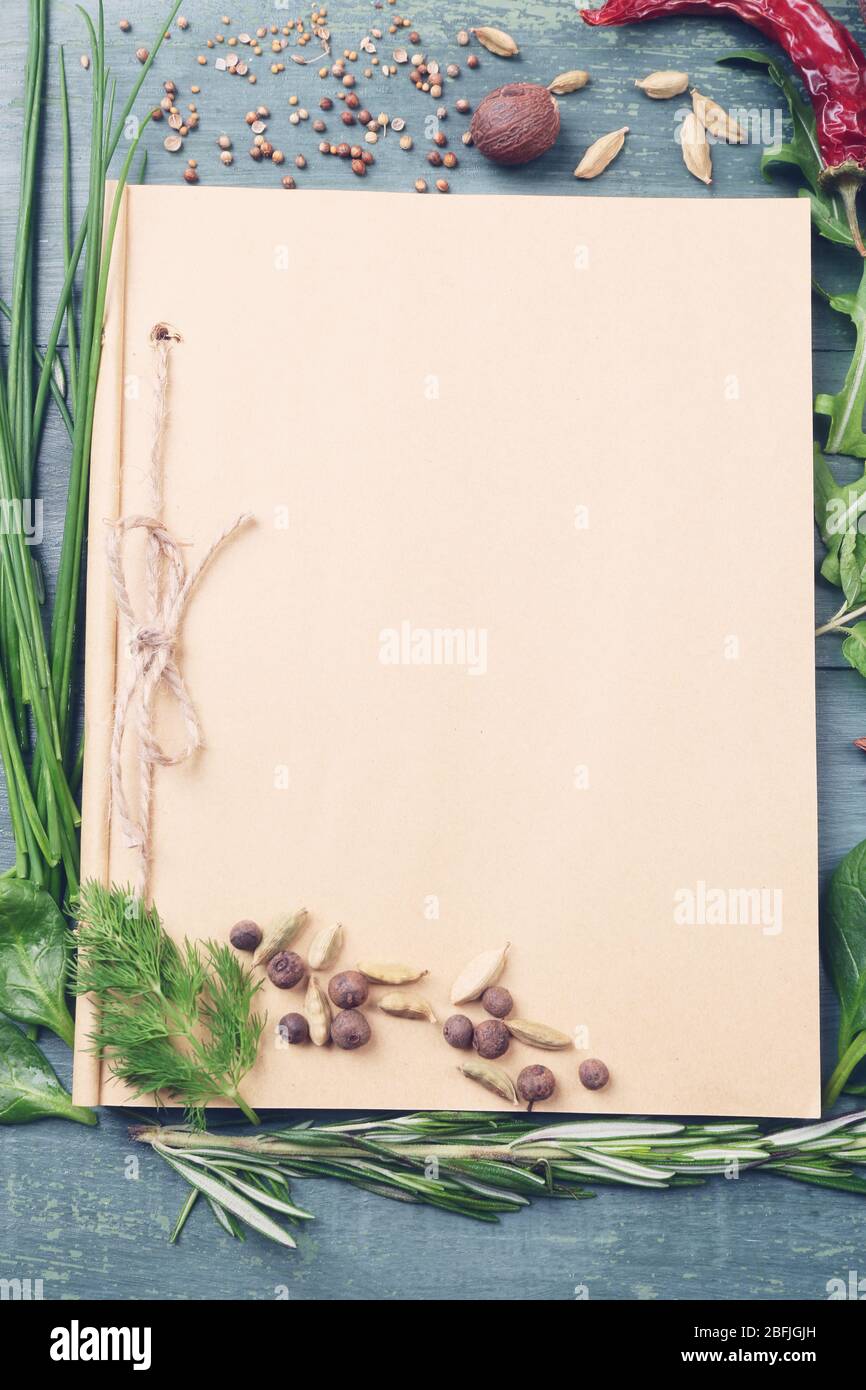 Recipe book page with different herbs on wooden background Stock Photo ...