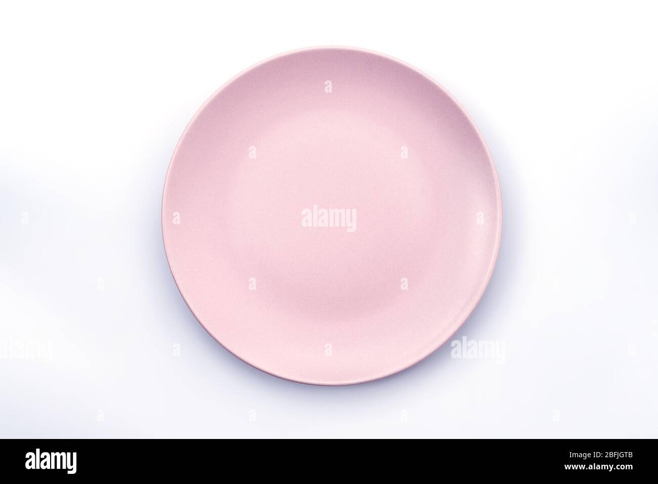 Empty Pink plate isolated on white background top view Stock Photo - Alamy