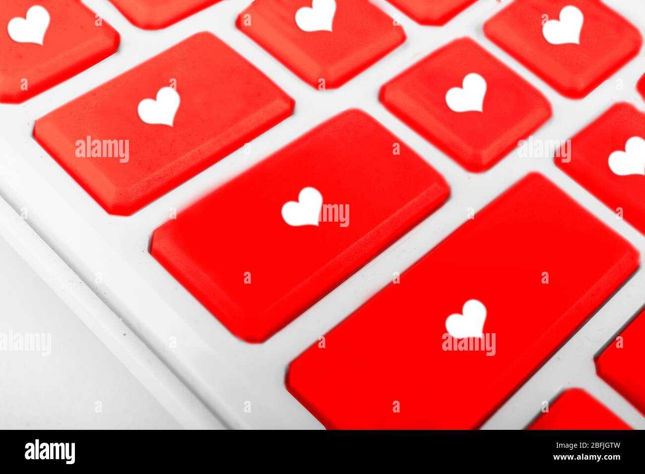 Close up of laptop keyboard with hearts icons Stock Photo - Alamy