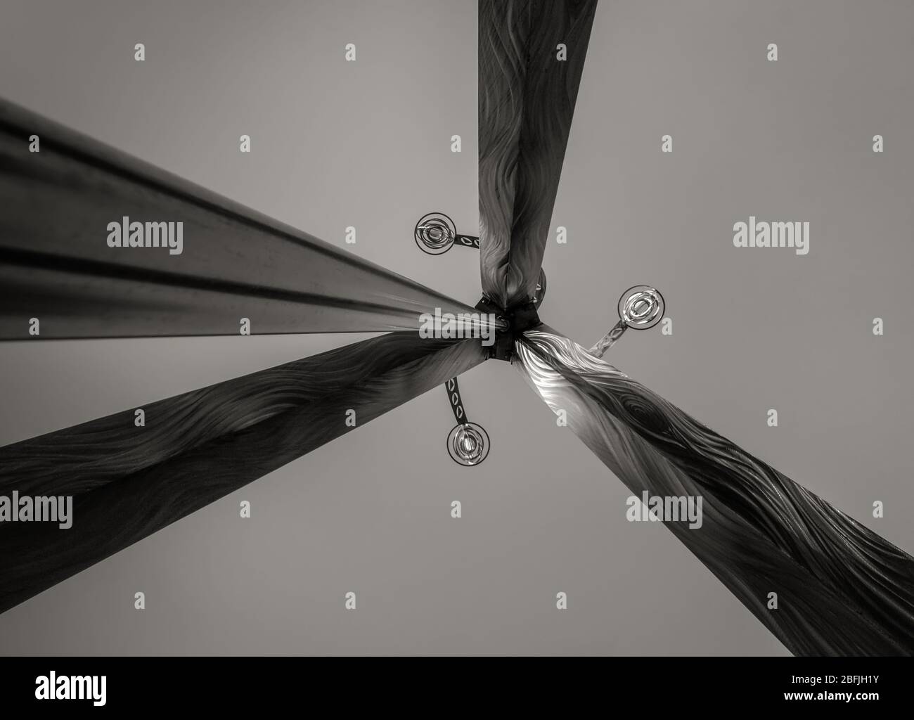 Light reflects off a chrome steel sculpture with sky background in ...