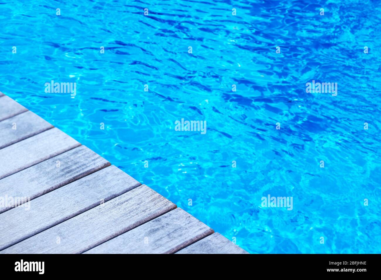 Wooden pier with blue sea background Stock Photo - Alamy