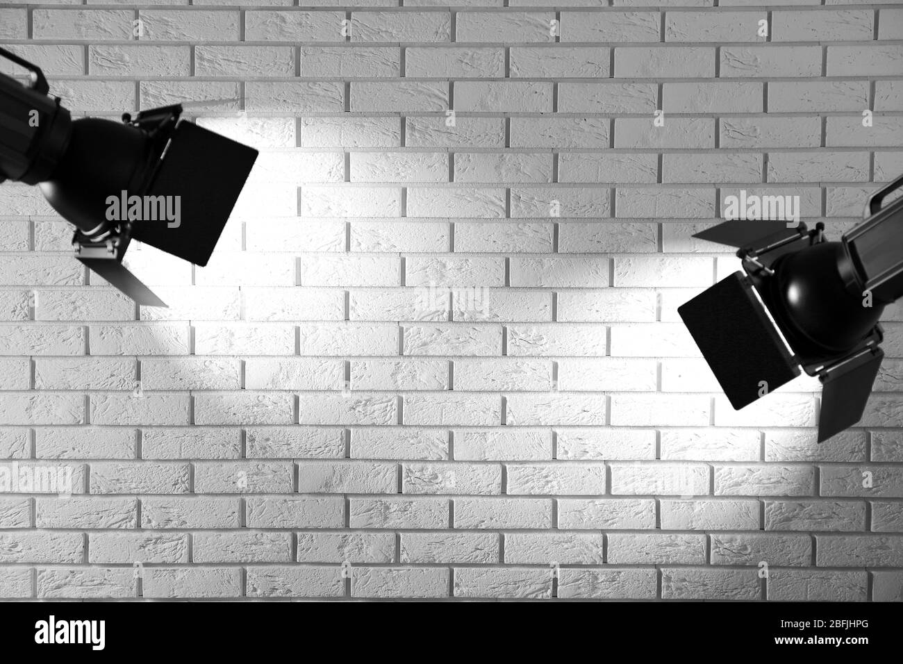 Photo studio with lighting equipment on brick wall background Stock ...