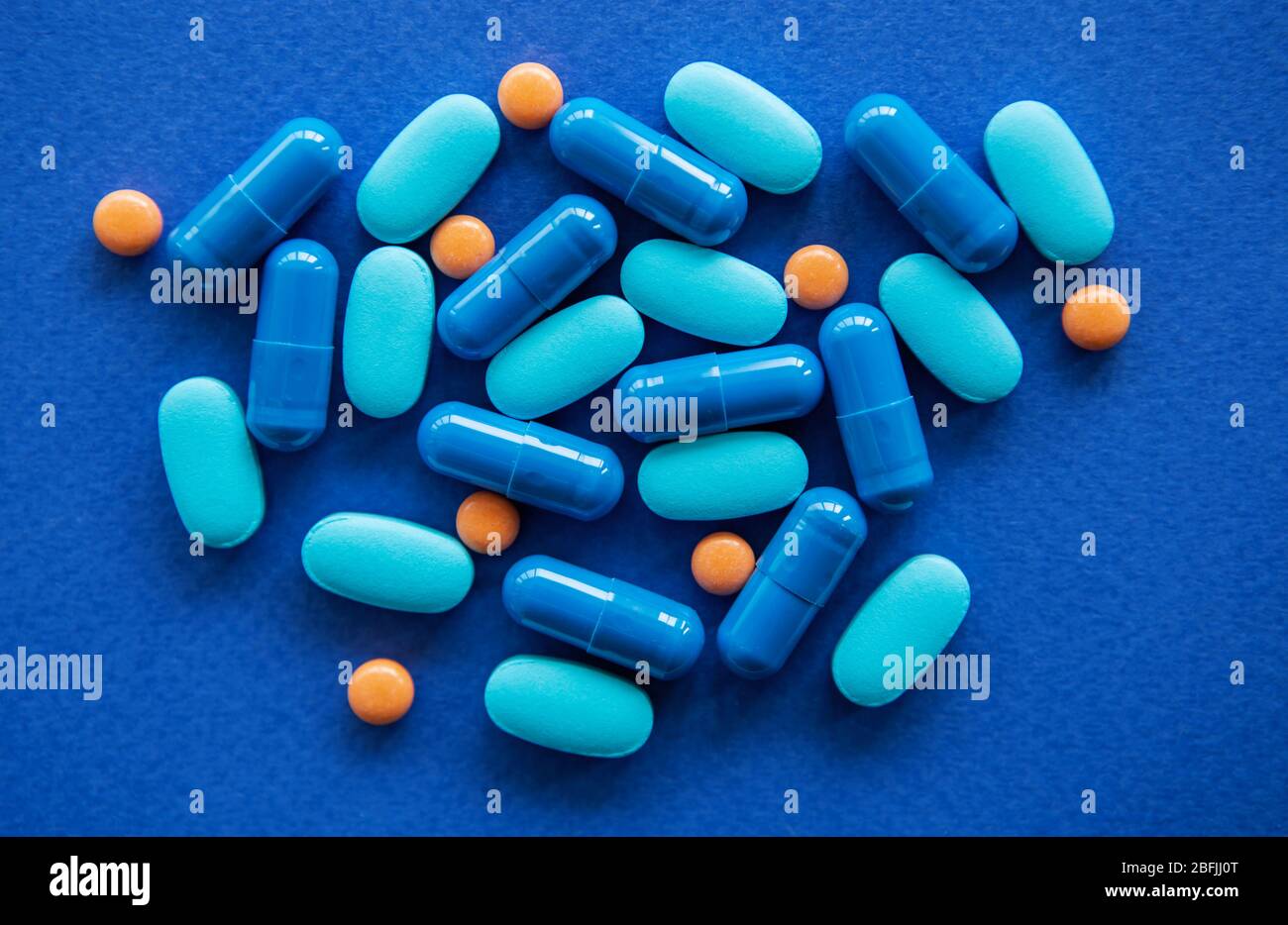 Blue medical pills in flat lay on classic blue background.Pile of ...