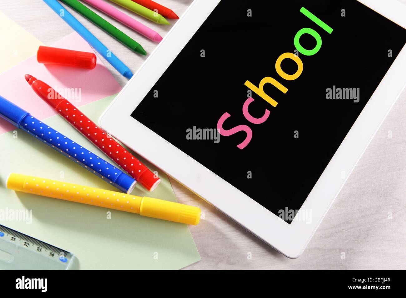Tablet PC with colorful markers on desktop background Stock Photo - Alamy