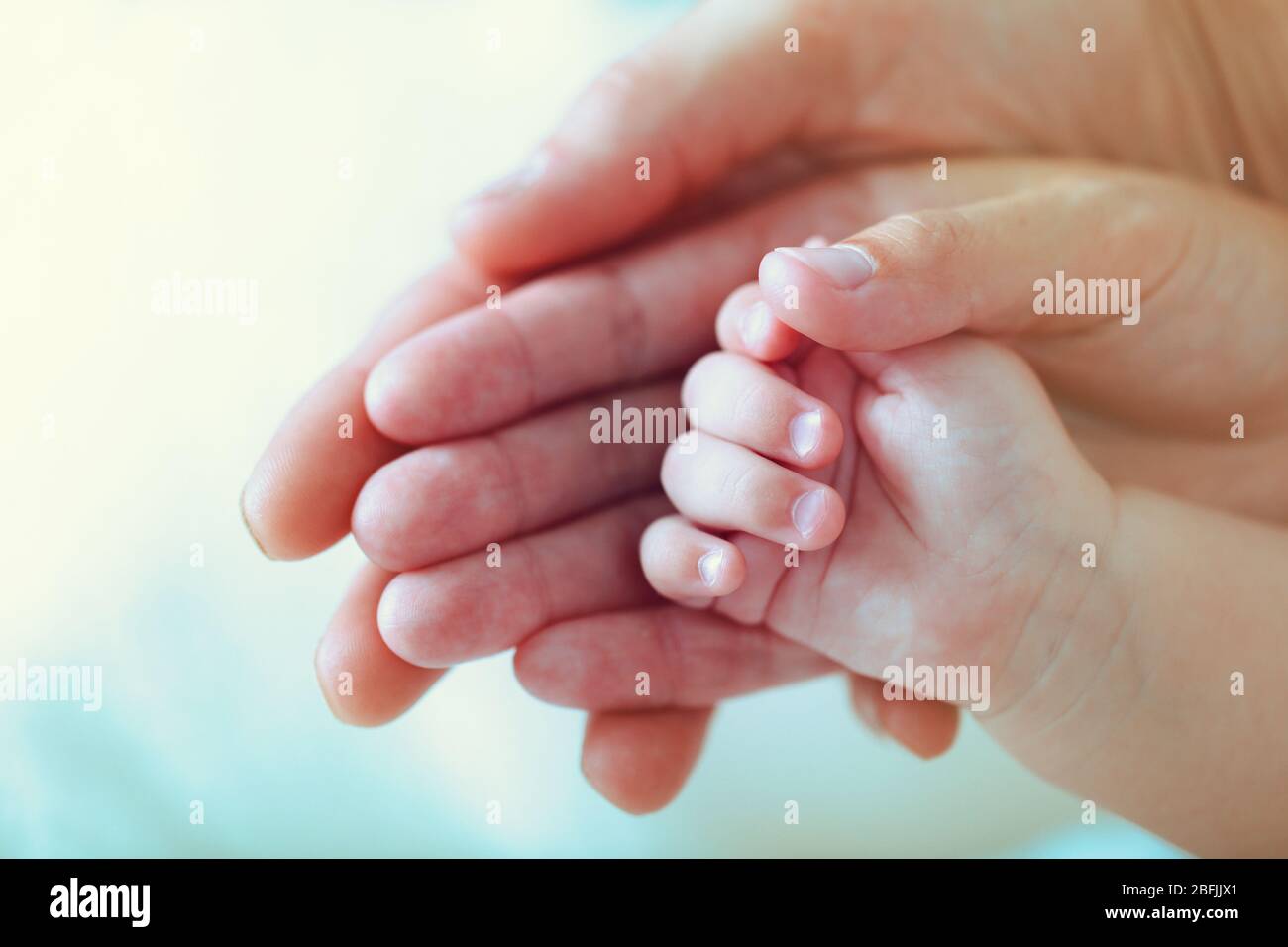 Adult and baby hands, closeup Stock Photo - Alamy