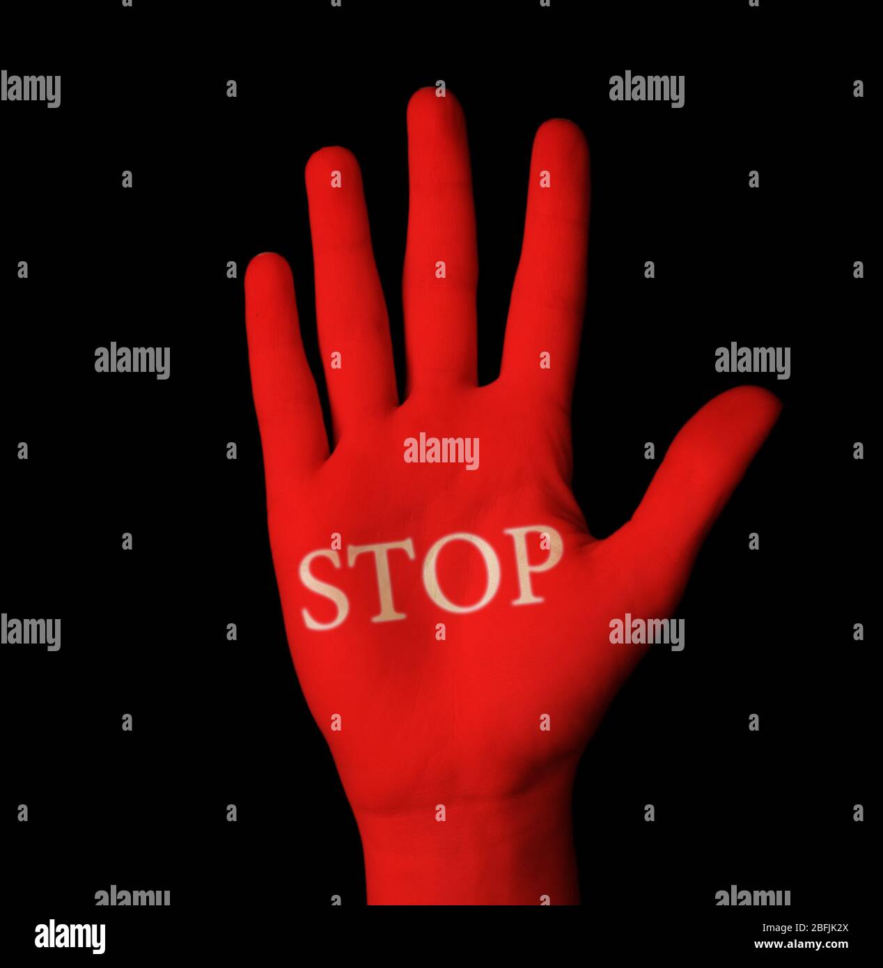 Red female hand with word STOP on black background Stock Photo - Alamy