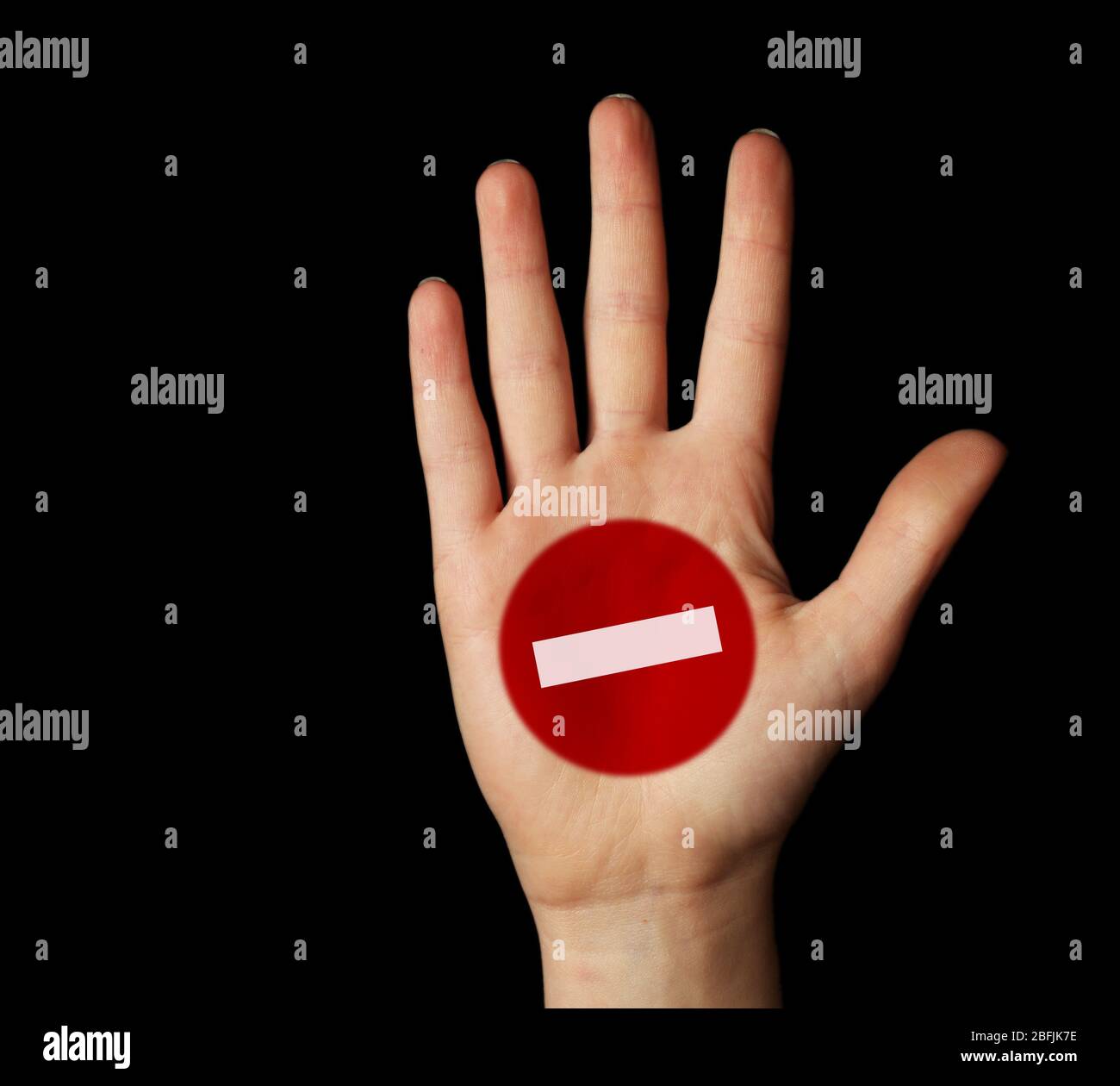 Female hand with sign STOP on black background Stock Photo - Alamy