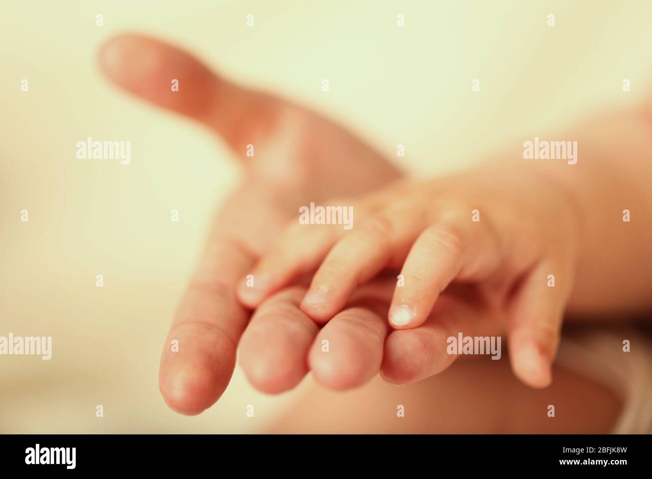 Adult and baby hands, closeup Stock Photo - Alamy