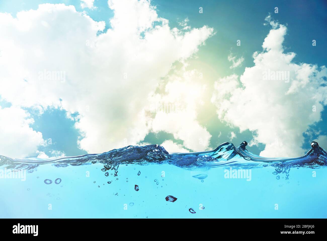 Water waves on sky background Stock Photo - Alamy