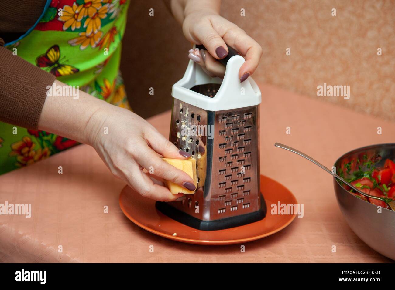 grating cheese on a metal grater in the home kitchen Stock Photo - Alamy