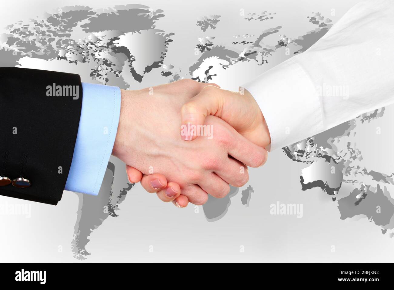 Business handshake on world map background Stock Photo - Alamy