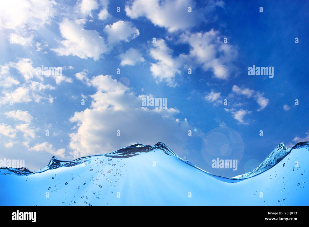 Water waves on sky background Stock Photo - Alamy