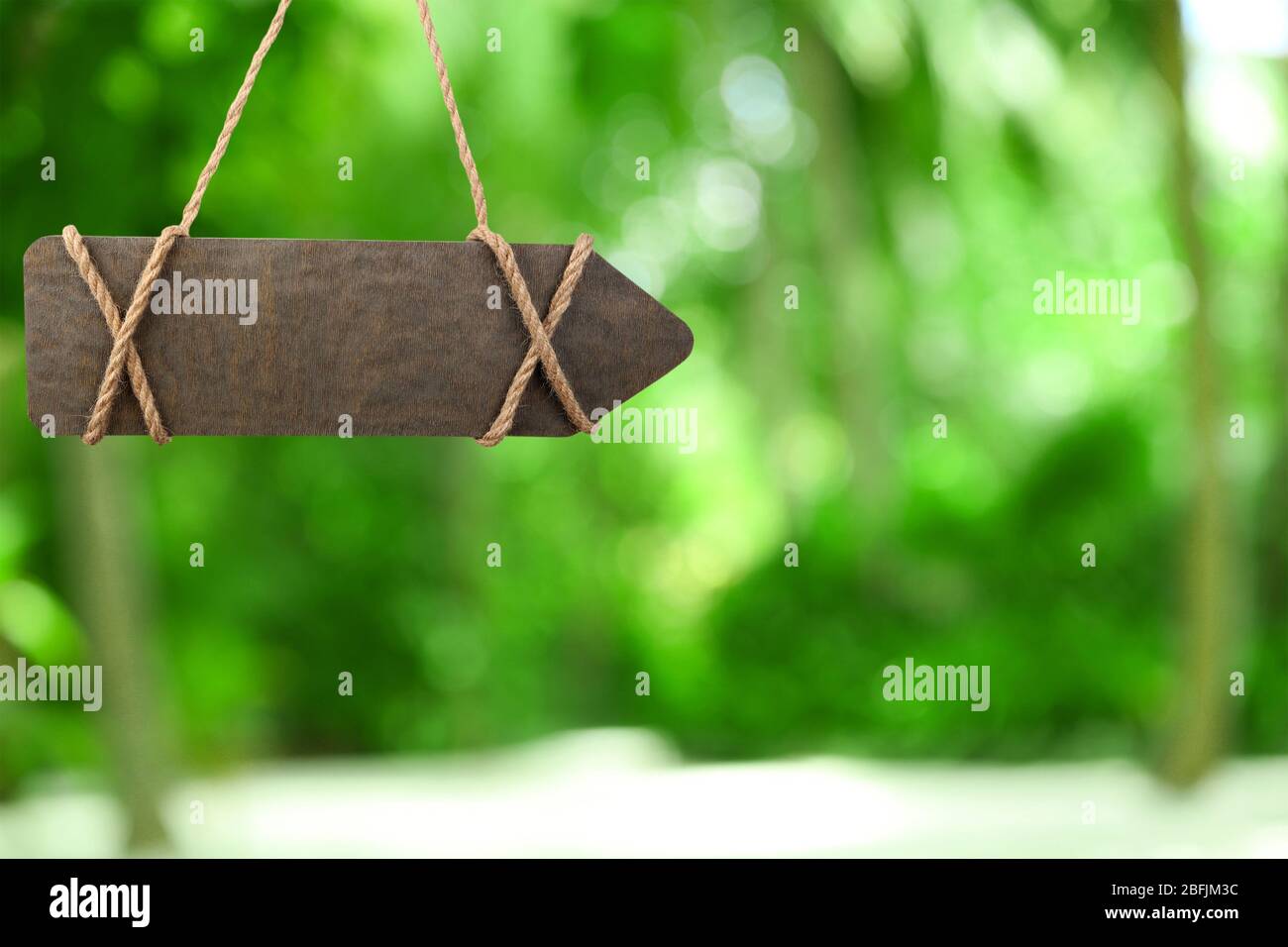 Wooden sign arrow on nature background Stock Photo - Alamy