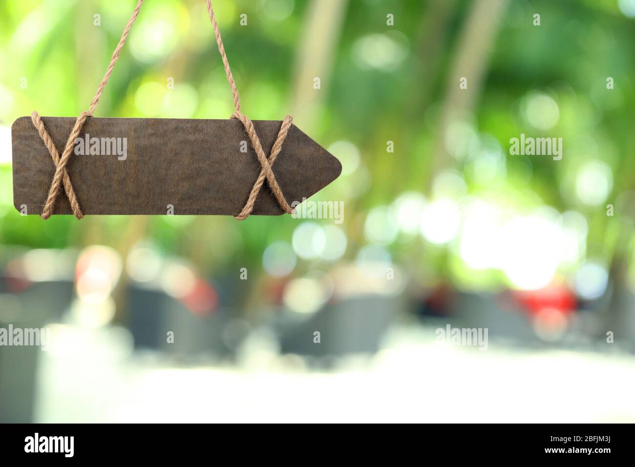 Wooden sign arrow on nature background Stock Photo - Alamy