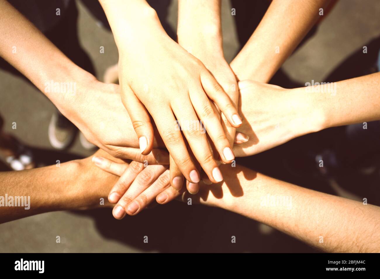 United hands outdoors Stock Photo - Alamy