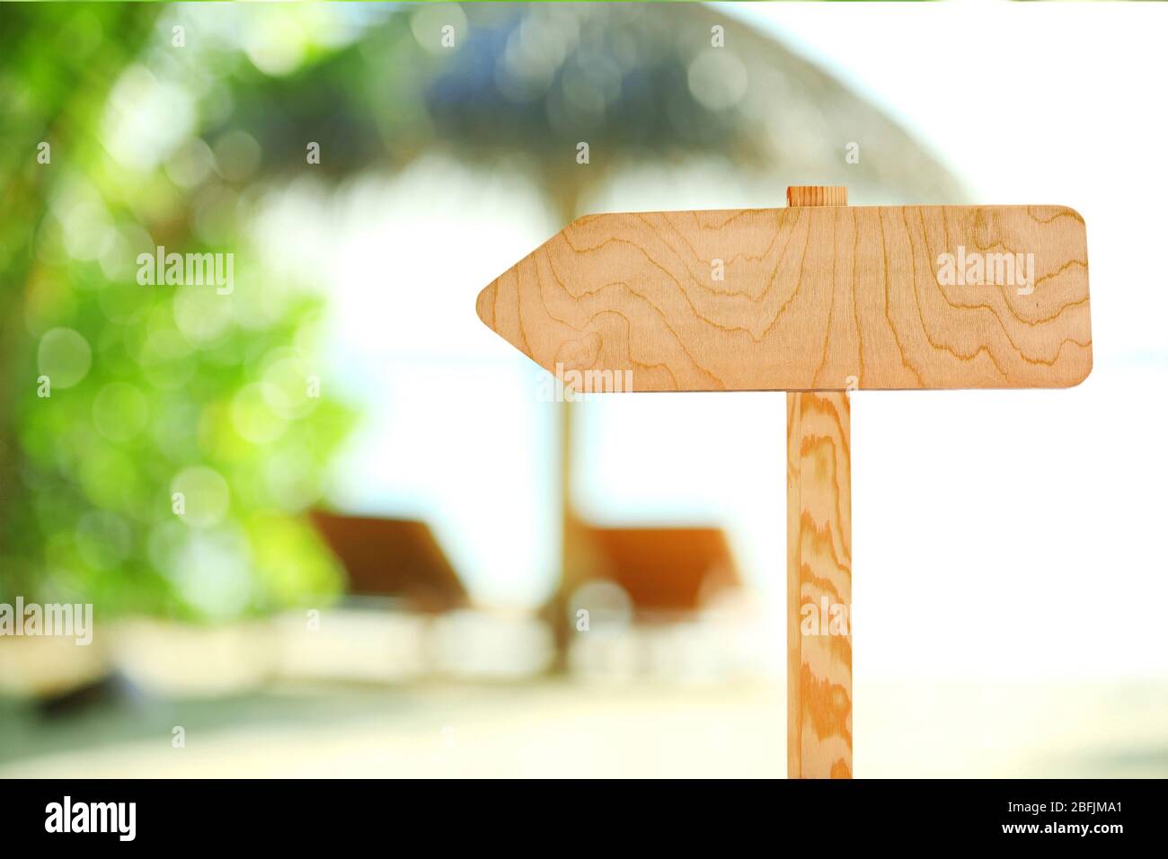 Wooden sign arrow on nature background Stock Photo - Alamy