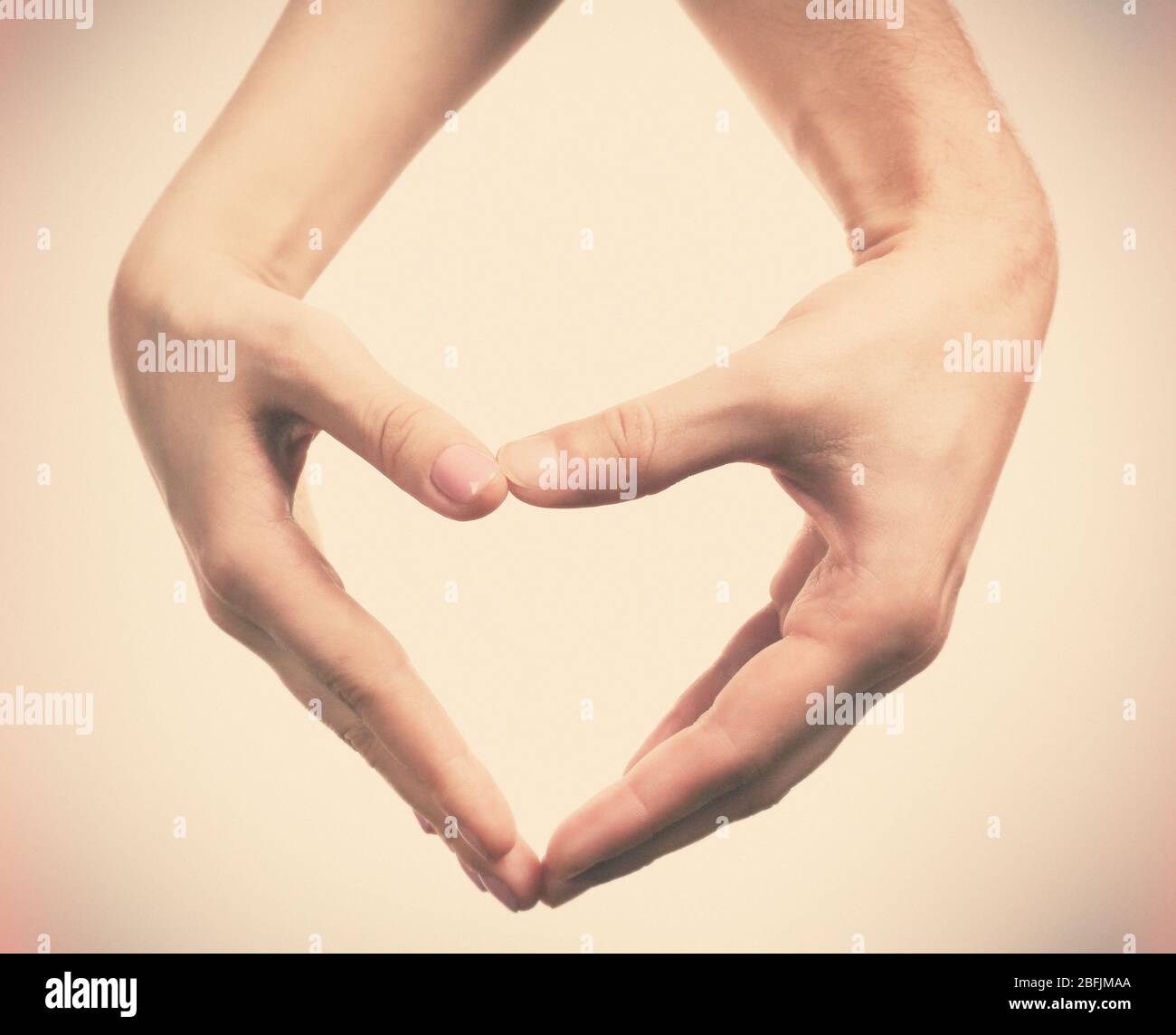 Heart shaped by male and female hands on light background Stock Photo ...