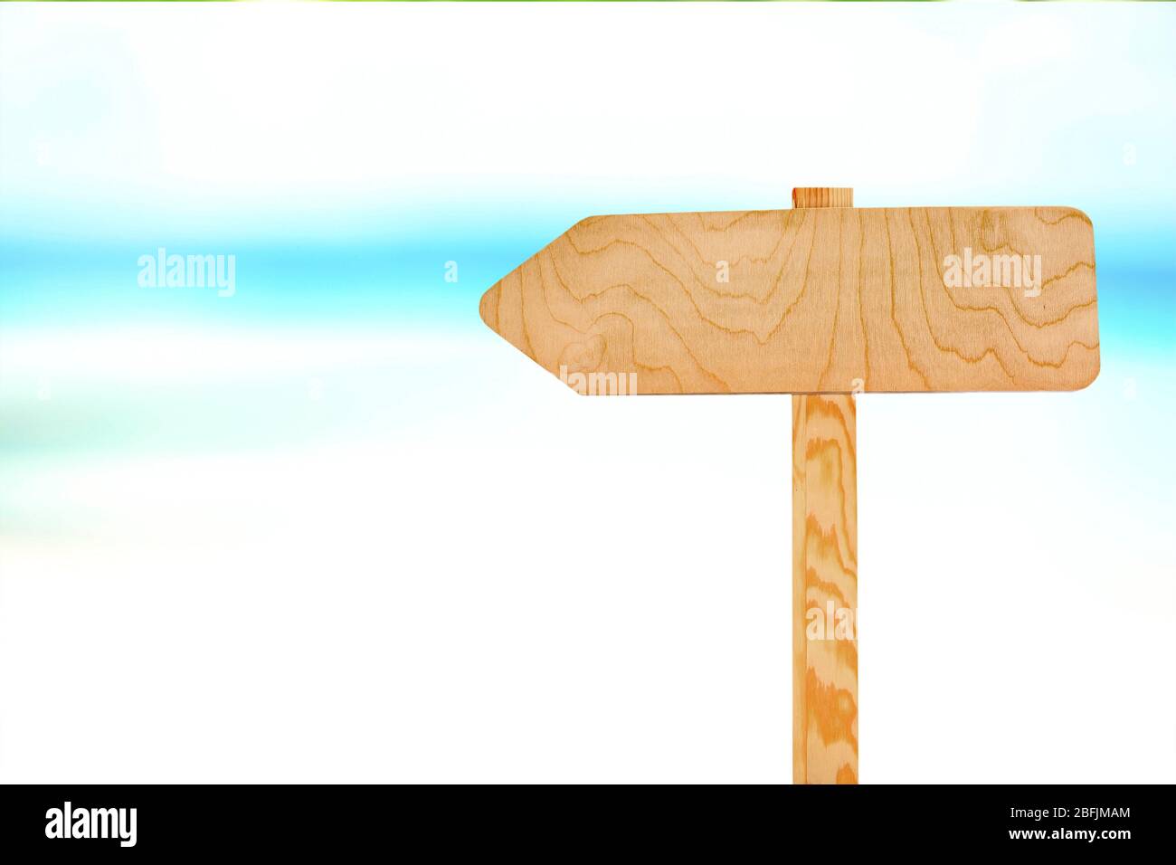 Wooden sign arrow on ocean background Stock Photo - Alamy