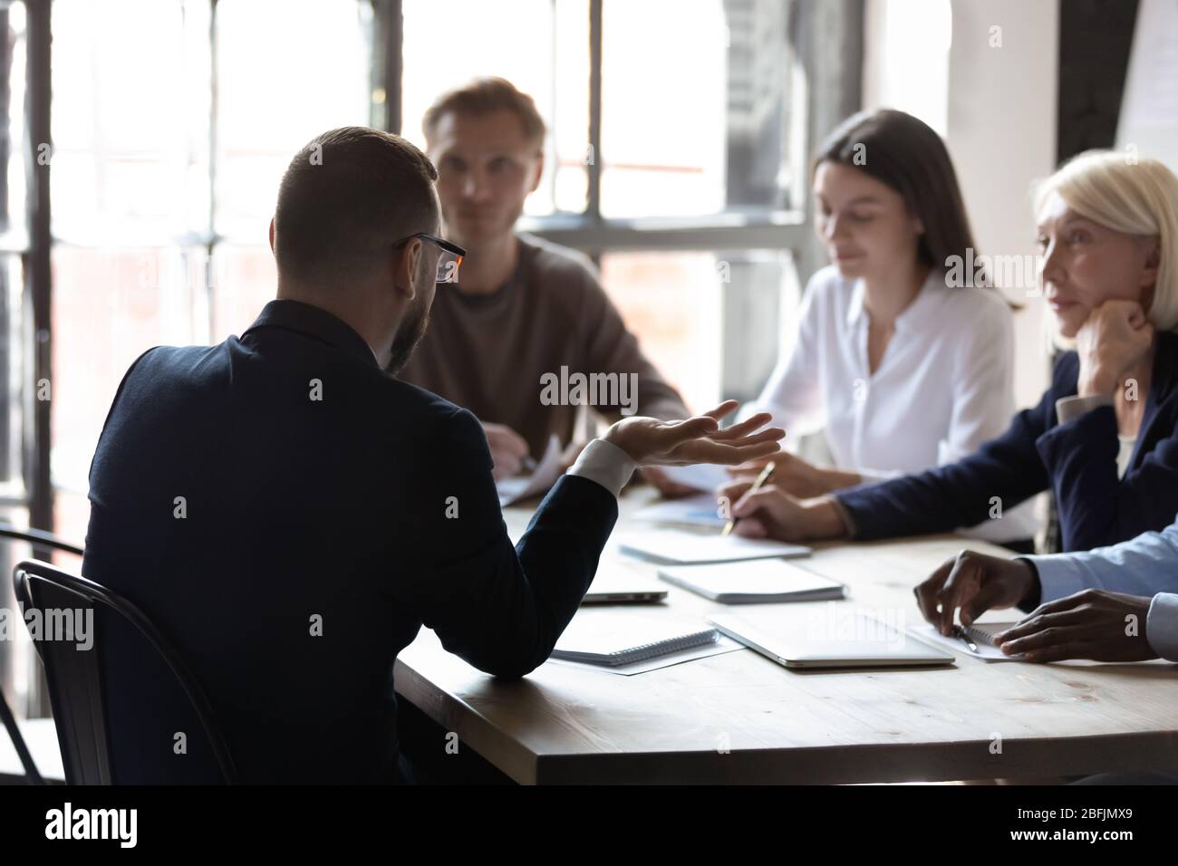 Male employee talk brainstorm with diverse colleagues at meeting Stock ...