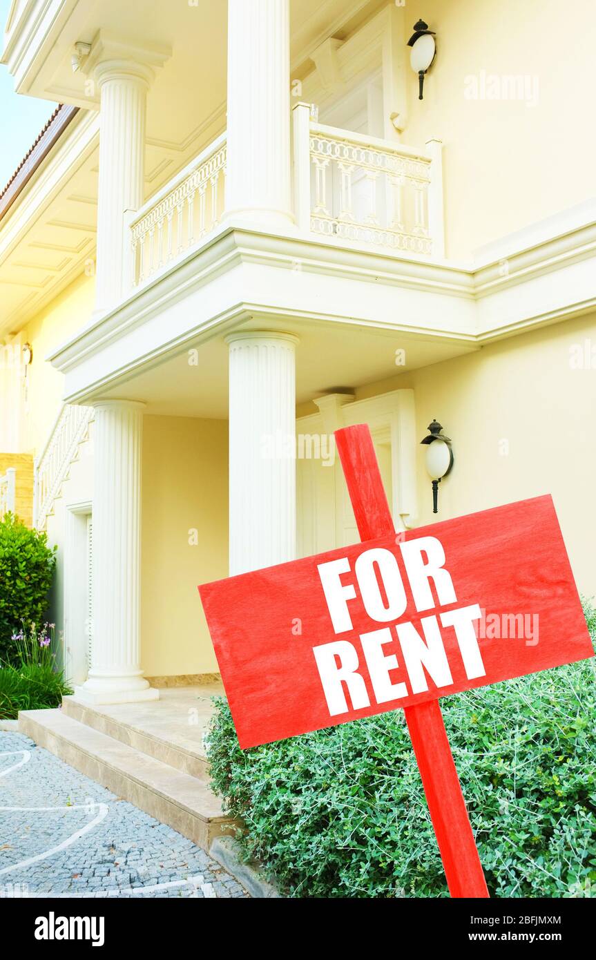 Real estate sign in front of new house for rent Stock Photo - Alamy