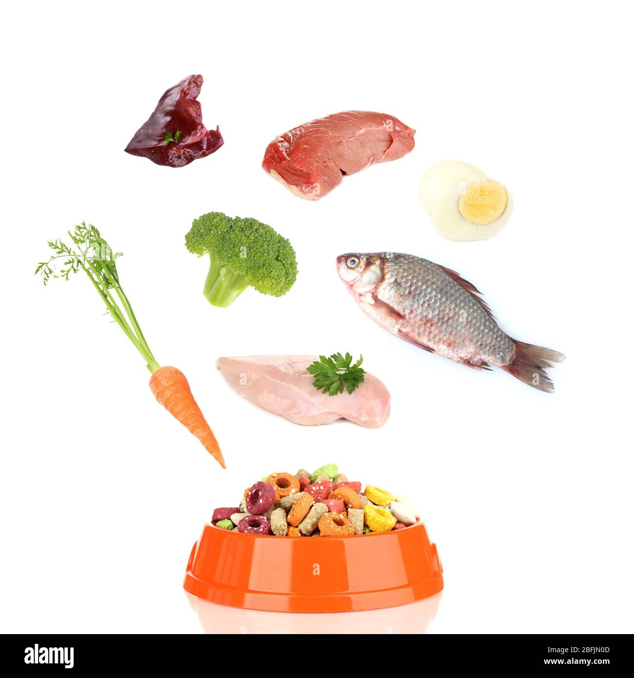 Concept of food for pets. Food falling in pet's bowl isolated on white ...
