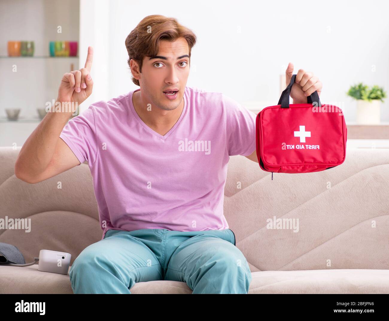 The sick man at home with first aid kit Stock Photo - Alamy