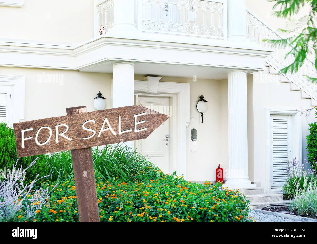 Real estate sign in front of new house for sale Stock Photo - Alamy